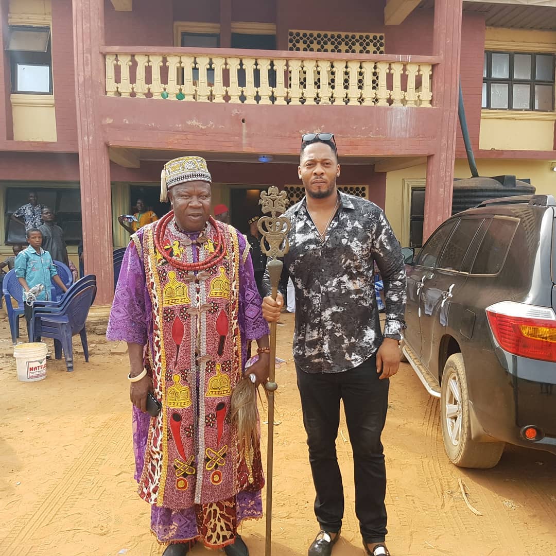 Prince Uche Okafor at his family house in Anambra, poses with his father