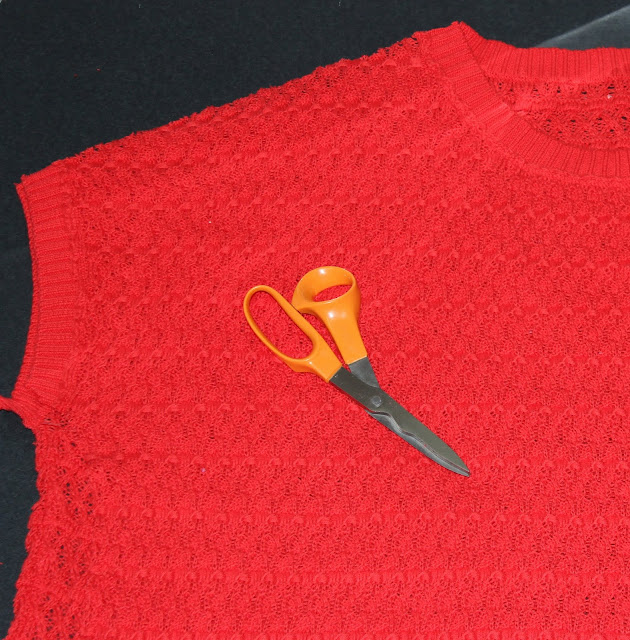 Cut out both the layers of the sweater.