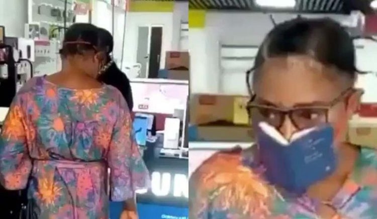 COVID-19: Woman Uses The Holy Bible As Face Mask In Lagos (Video)