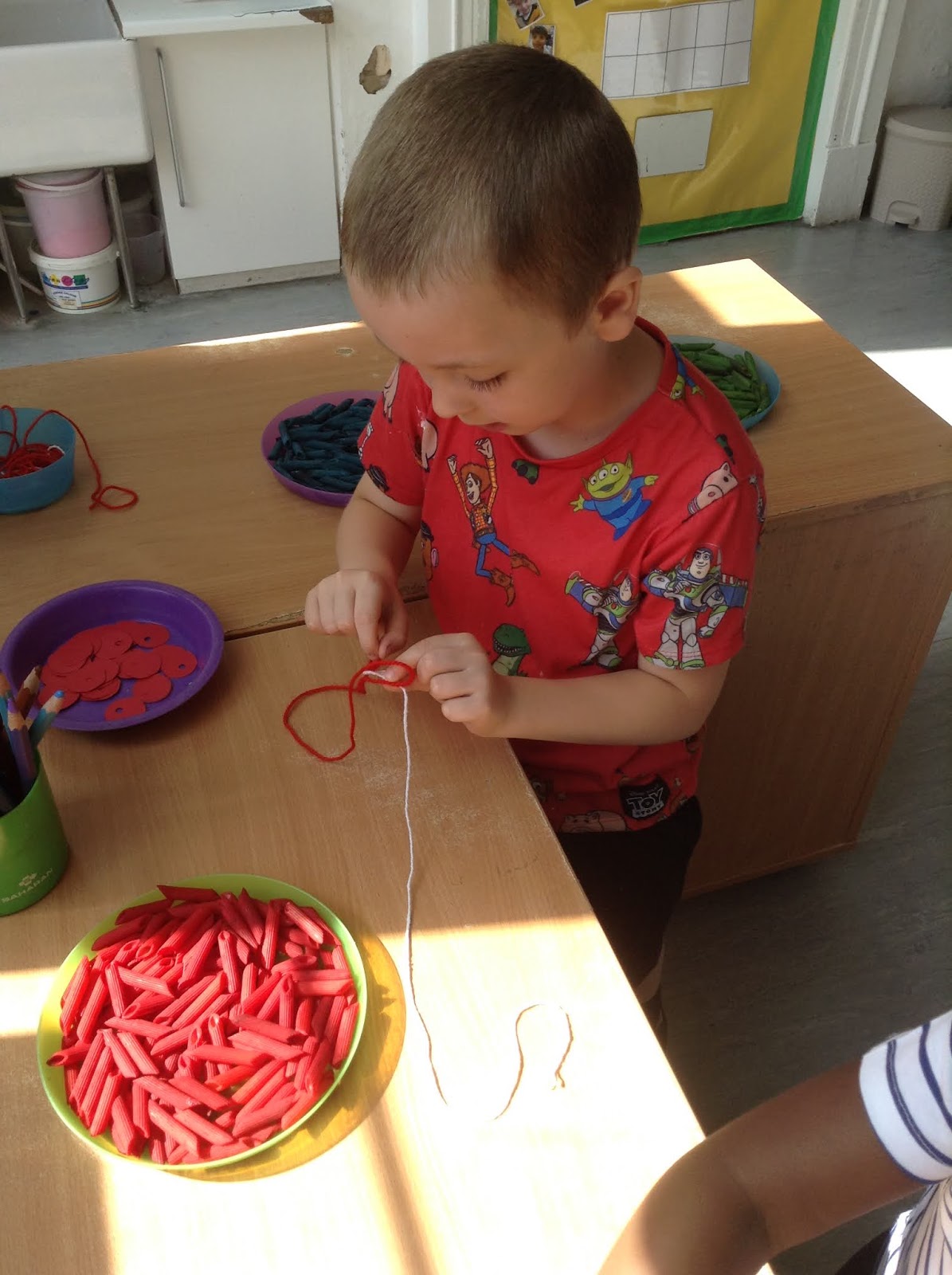 Early Years: Caterpillar Necklace Threading