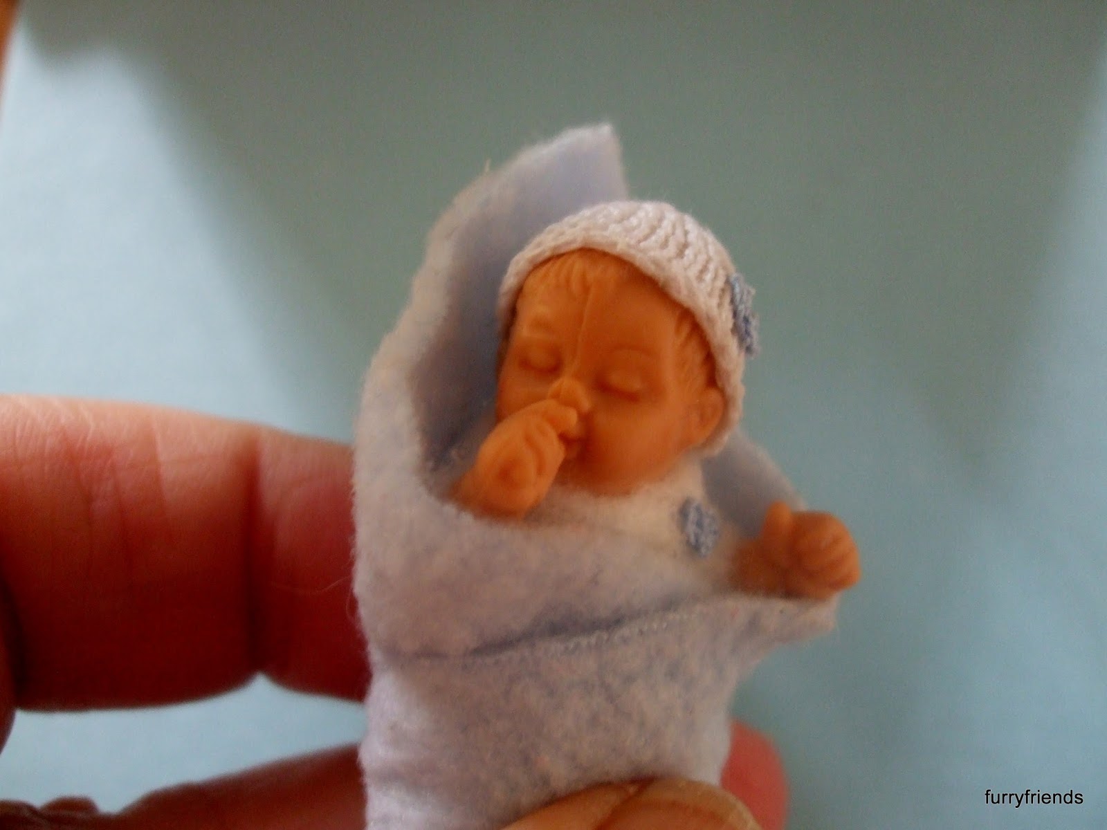 Marianne's Miniverse: A swaddled mini baby.
