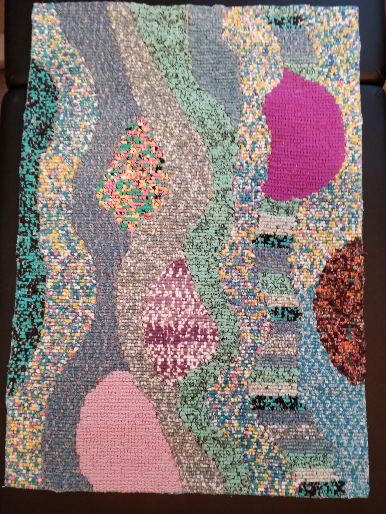 Stamp Queen: Locker hook rug with random patterns.