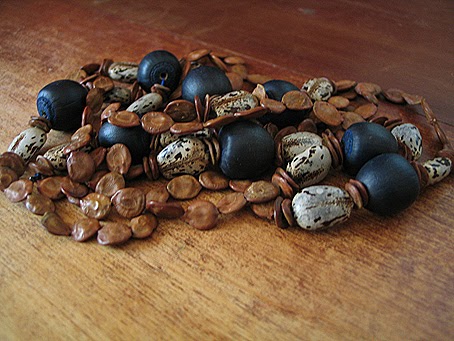 string a necklace made from seeds | Art Education Daily