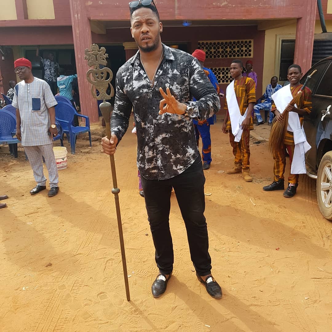 Prince Uche Okafor at his family house in Anambra, poses with his father