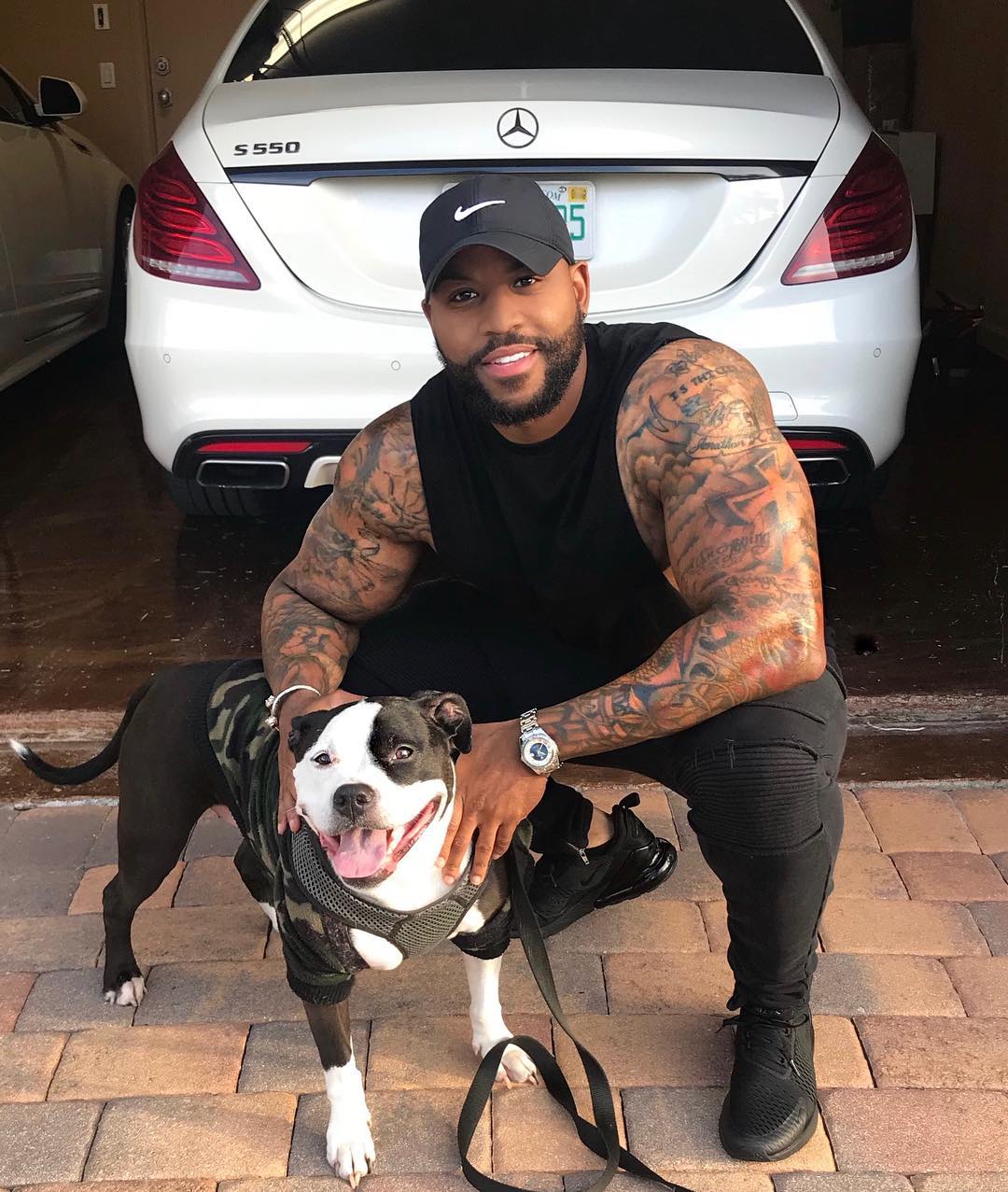 Cars, Dog: Joshua Benoit poses with his dog and cars.