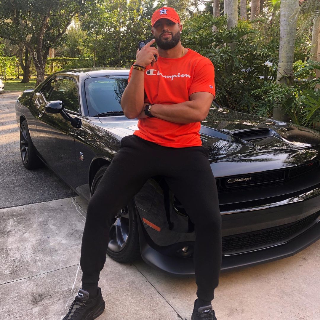 Kevin Portillo poses with his car (photo)