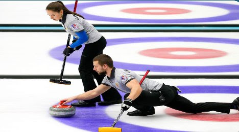 What winter sport is played on ice with polished heavy stones?