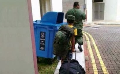 Boy carries field pack and duffel bag for SAF soldier - www.NoelBoyd.com