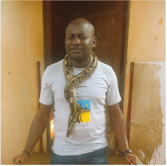 A Nigerian twitter user, Damola posed with a python wrapped around his ...