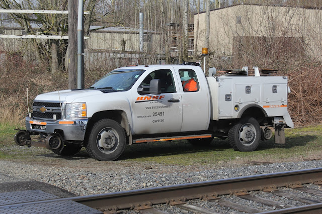 Railfan in Sumas, WA: sunny, BNSF road/rail capable truck 25491, 11:30am..29 Feb, 2016.