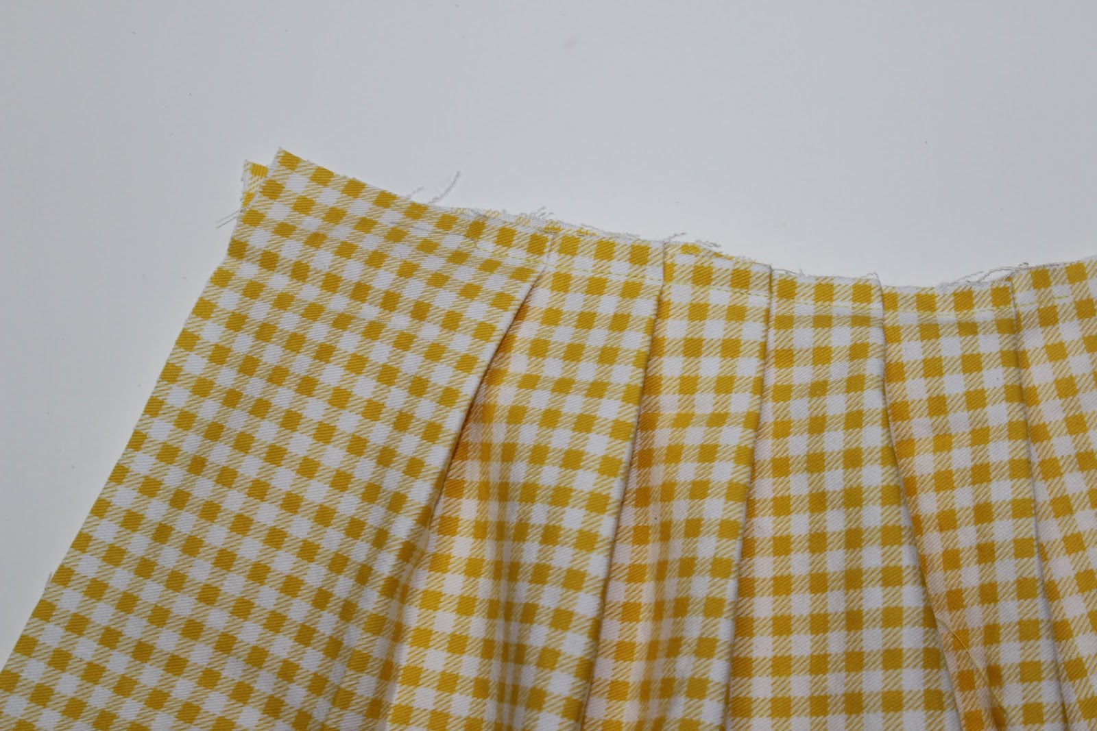 6. Sew the top of the pleated rectangle on the top of the shorts front ...