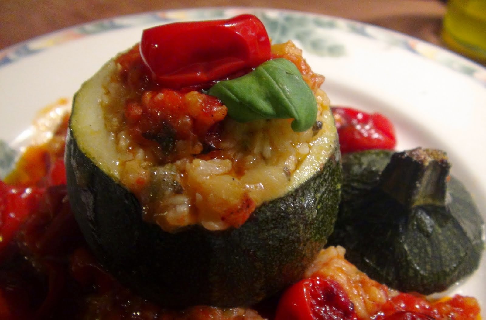 Rice stuffed round zucchini (courgettes) with cherry tomatoes and basil