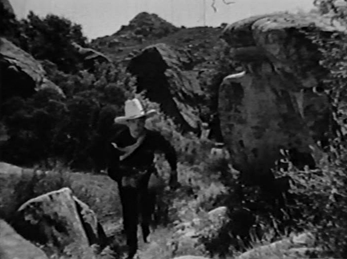 Iverson Movie Ranch: Charles Starrett scrambles over movie rocks in ...
