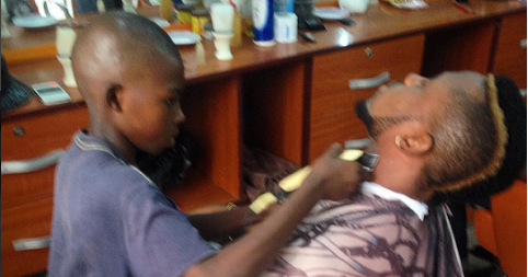 Meet a 10 year old barber who makes at least N5,000 daily