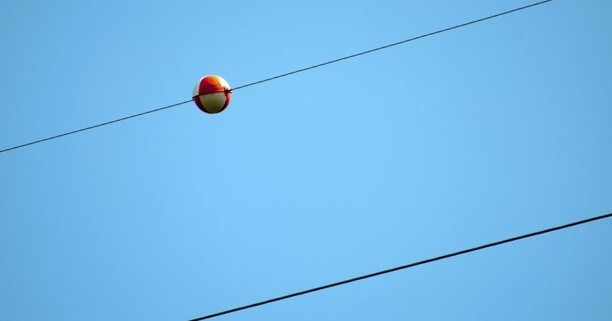 What are the colored balls hanging on power transmission line cables ...