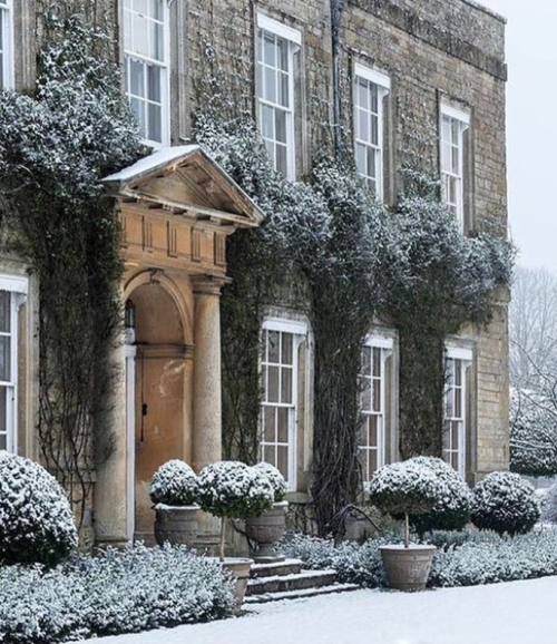 Snow is such beautiful decoration for the plantings around this English ...