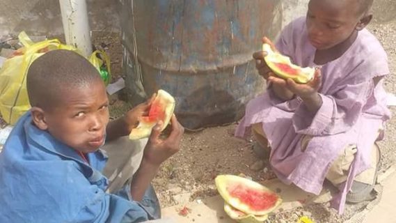 Photos: Two children spotted eating from a garbage drum in Kano