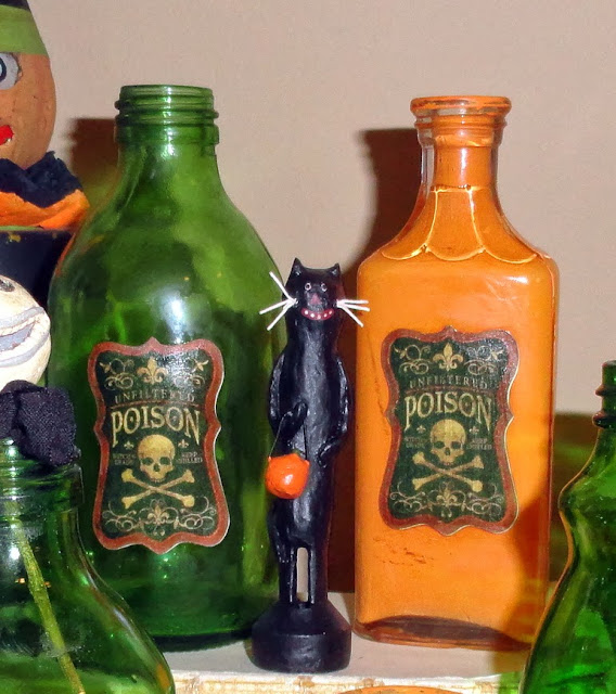 Painted glass jars with mod podge poison labels