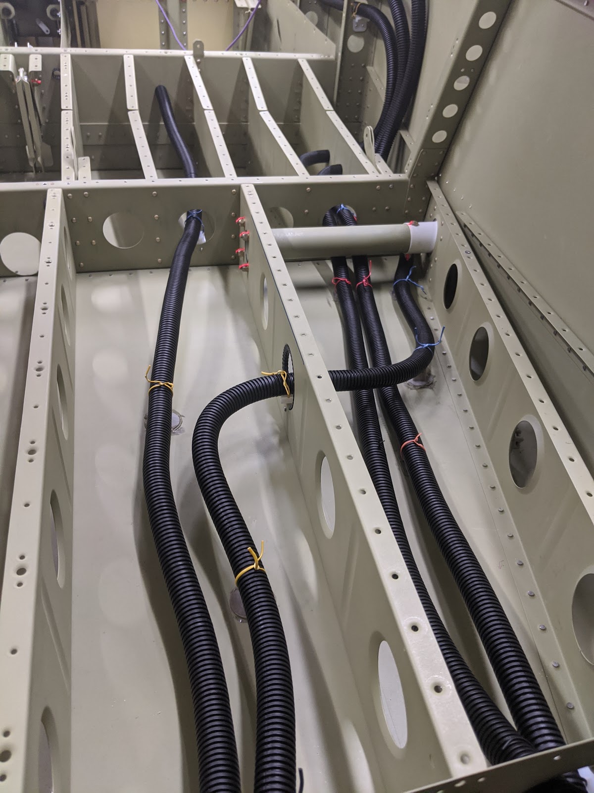 Damazio family's RV-10 project: Baggage area conduits and floors installed