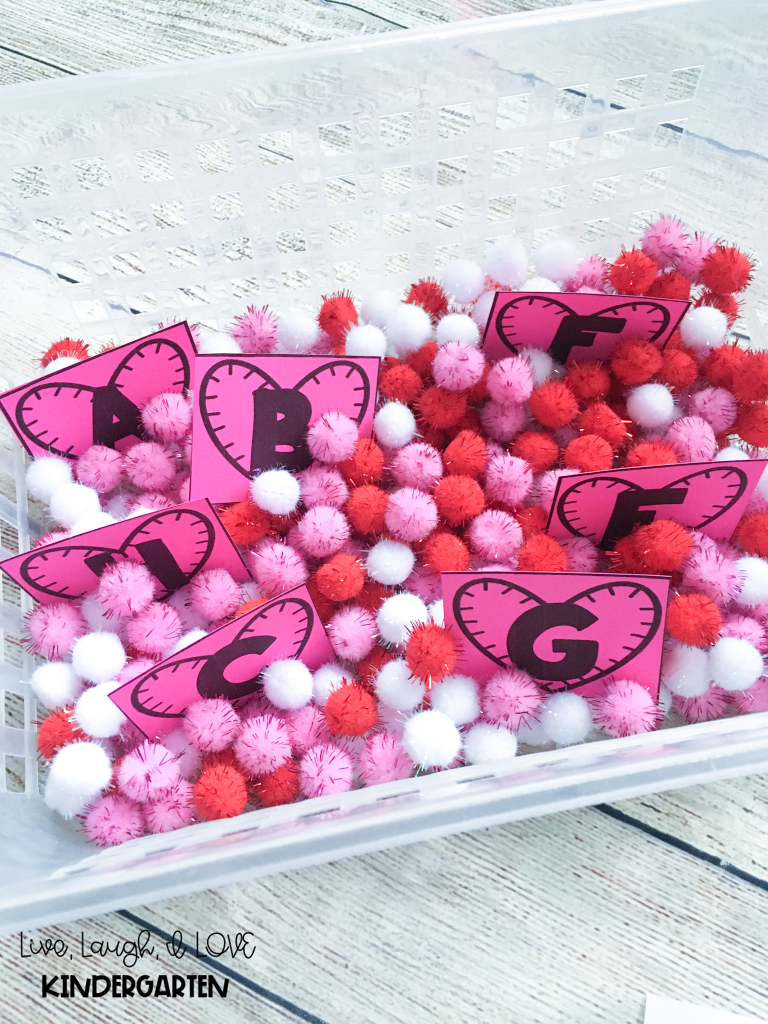 I added sparkly pink, red, and white pom poms to this bin. I printed ...
