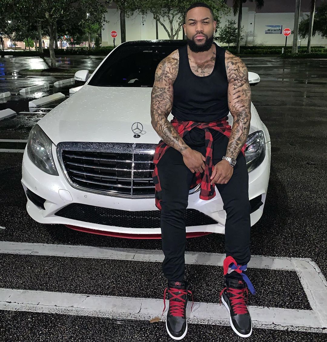 Cars, Dog: Joshua Benoit poses with his dog and cars.