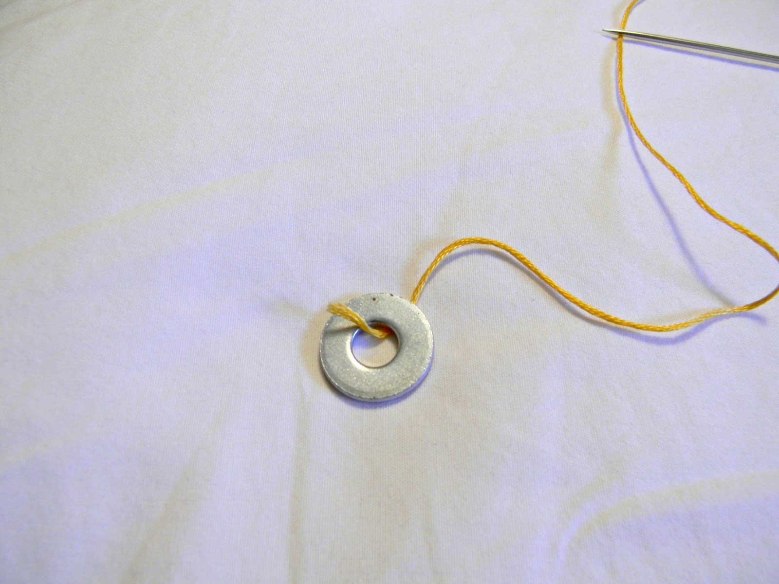 First up, grab your small washer. Thread your huge needle with your ...