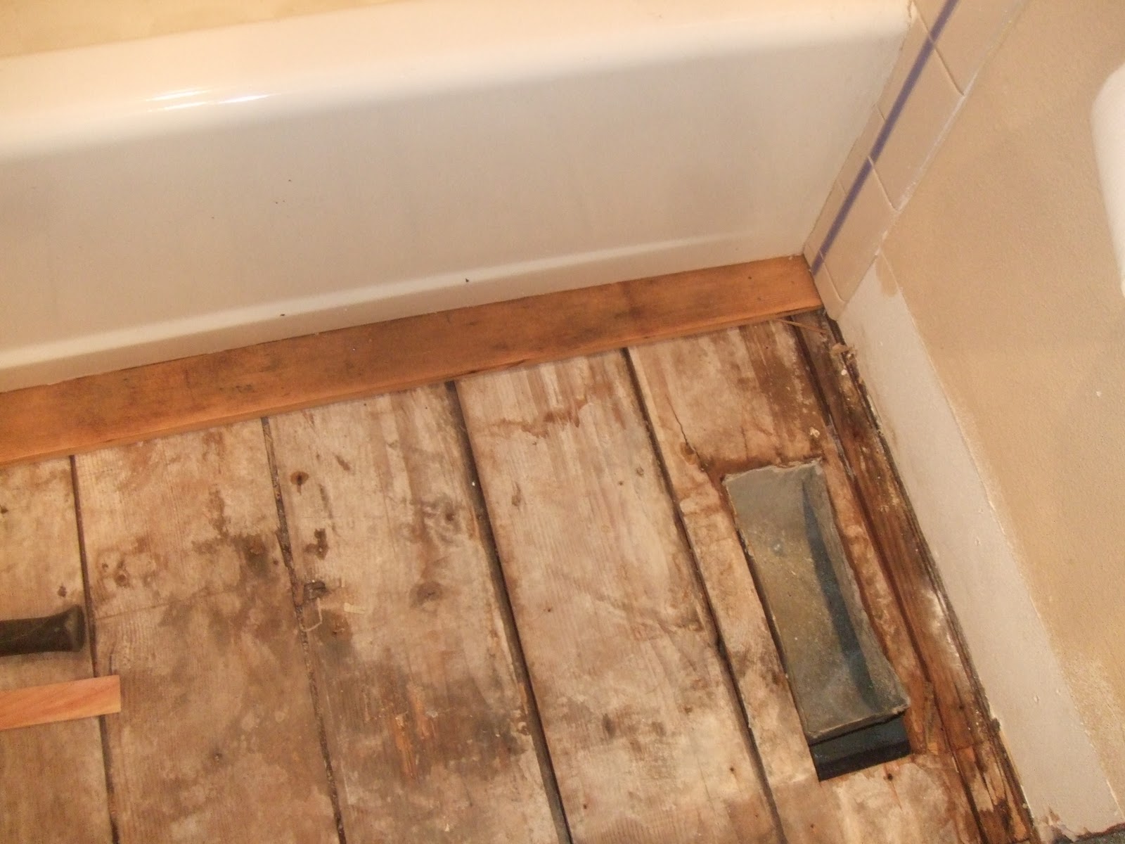 The Smiths: Laying bathroom wood flooring