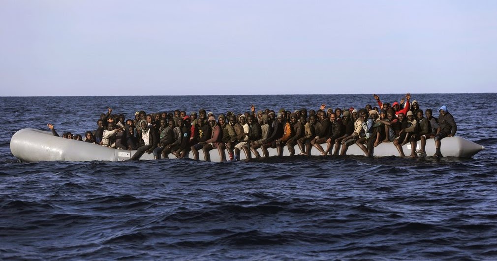 Migrant Crisis : People crowd a rubber boat as they are rescued...