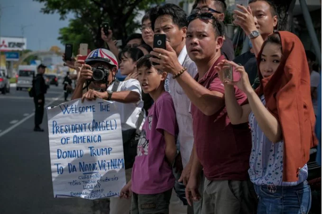 PHOTOS: Trump’s Convoy Passes Vietnamese Street, Sign In The Crowd ...