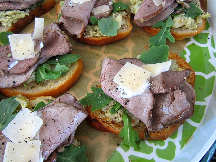 Filet of Beef Crostini w/ Artichoke Pesto & Parmesan Curls