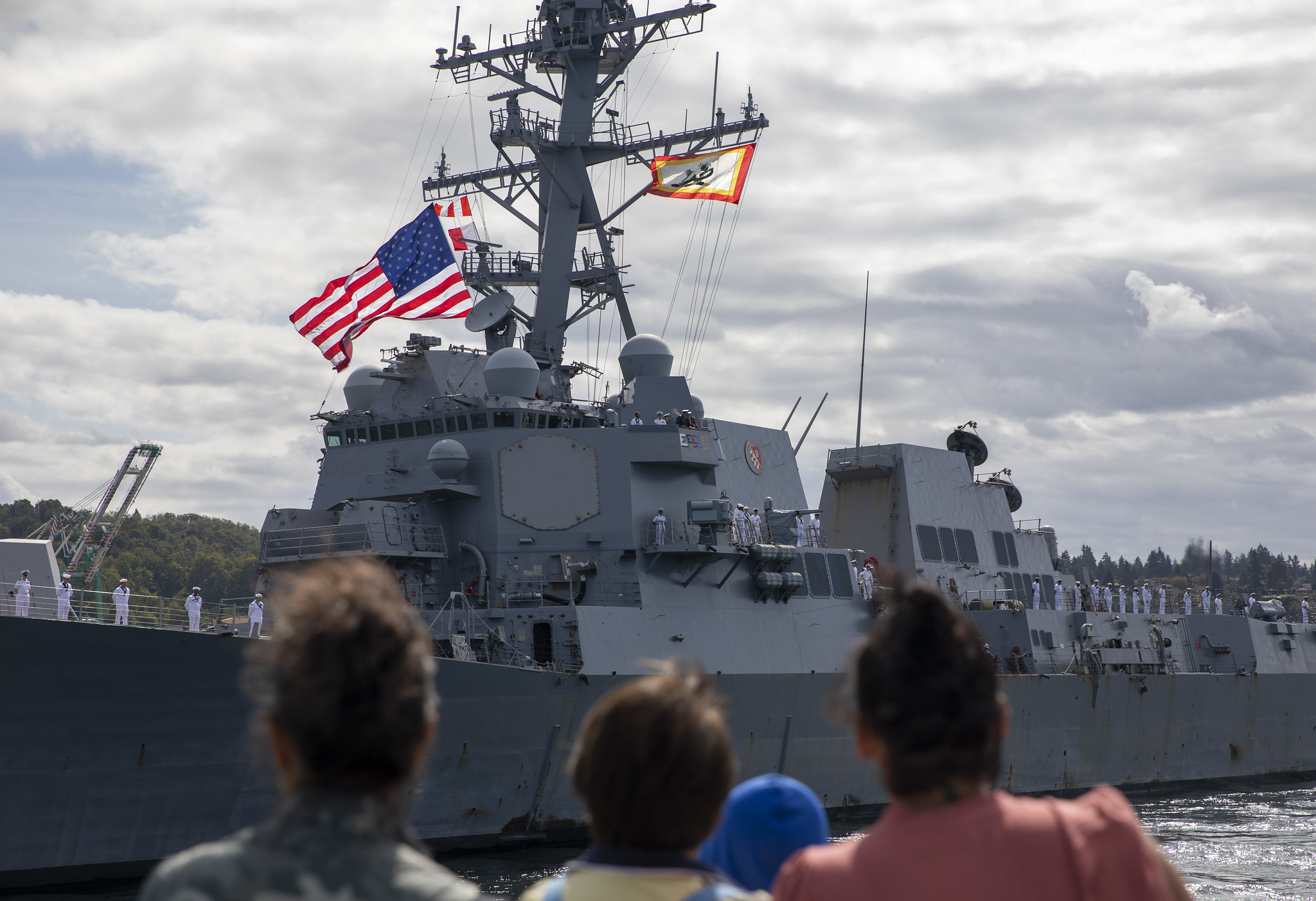 A family member watches as Arleigh Burke-class guided-missile destroyer ...