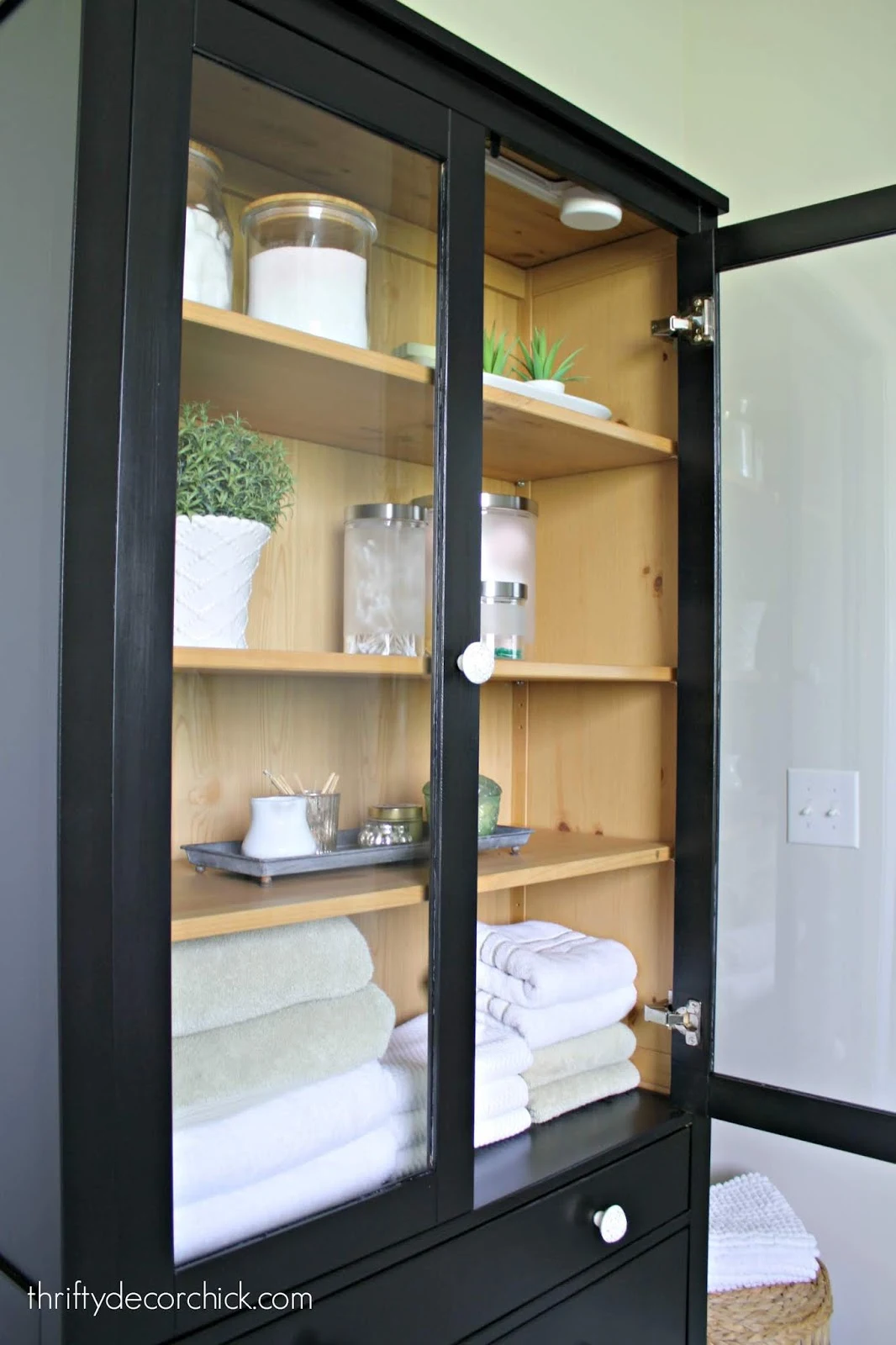 Hemnes glass cabinet makeover in bathroom | Thrifty Decor Chick ...