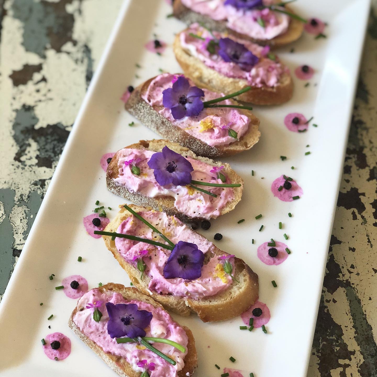Garlic Toast Points with Marbled Beet Chevre and Edible Flowers
