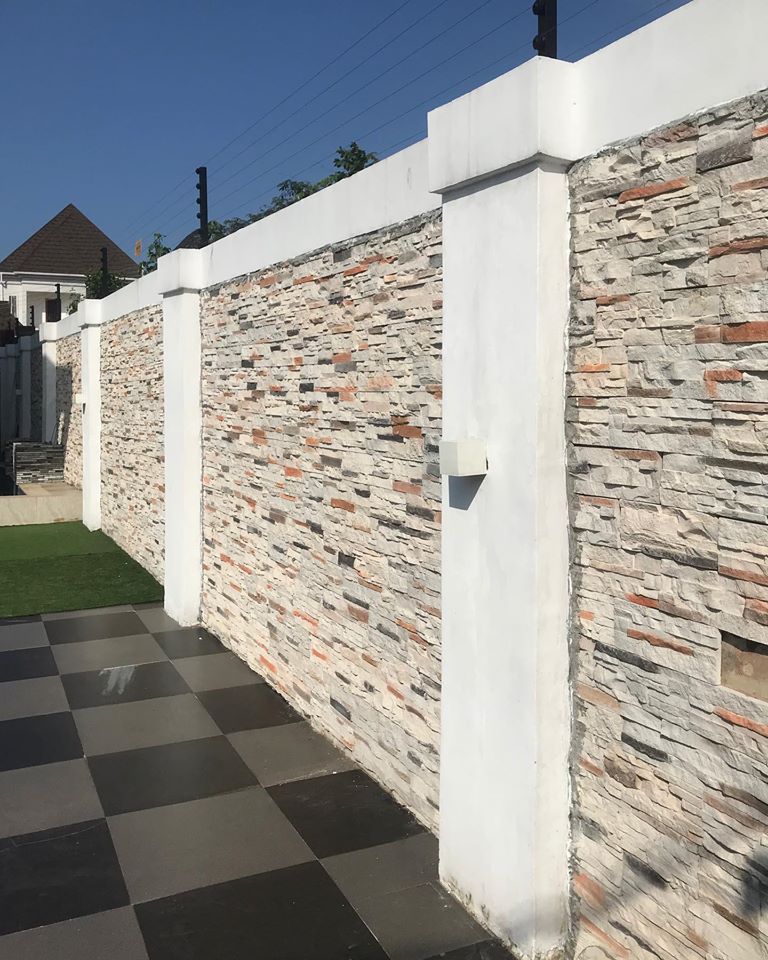 White Ez Fit Stone On a Building Fence