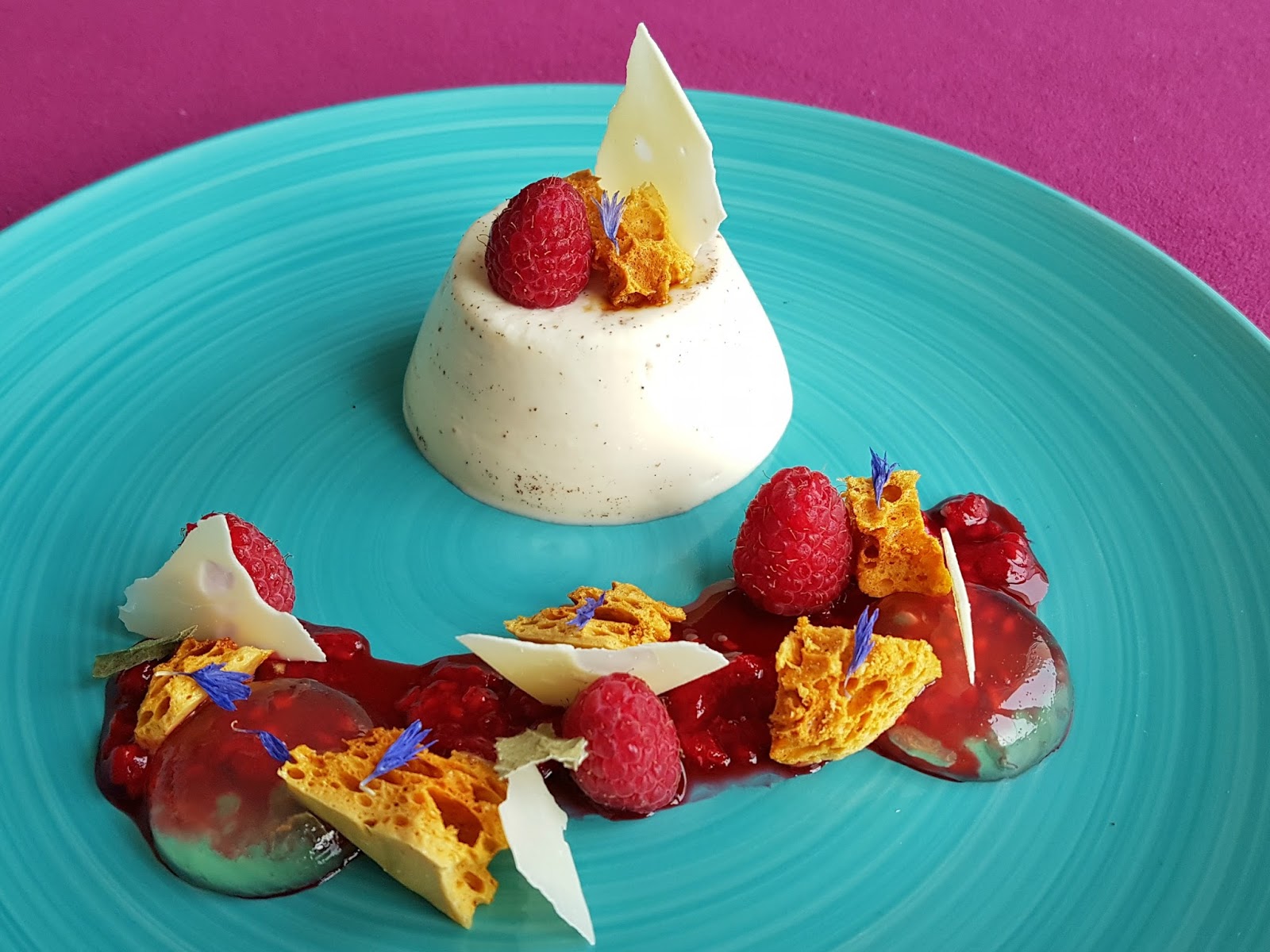 Vanilla panna cotta, honeycomb and raspberries