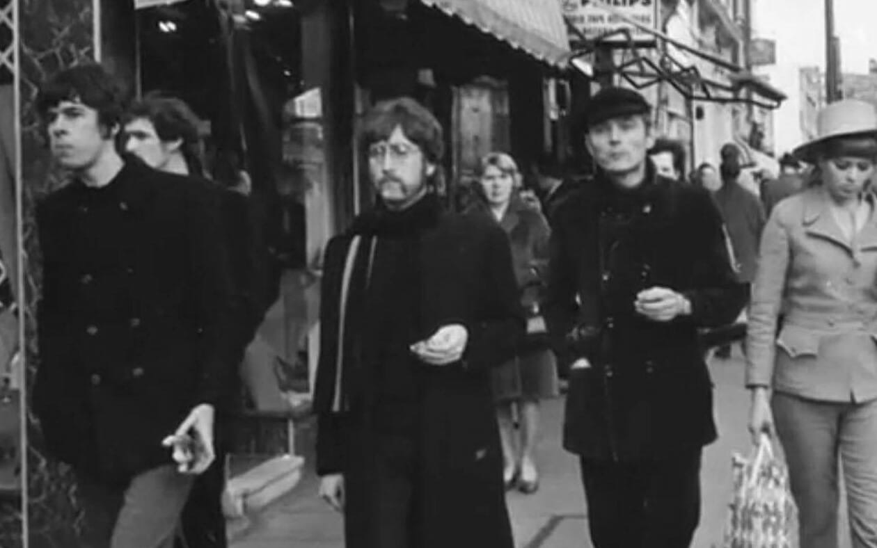 Meet the Beatles for Real: John tries to blend into the crowd