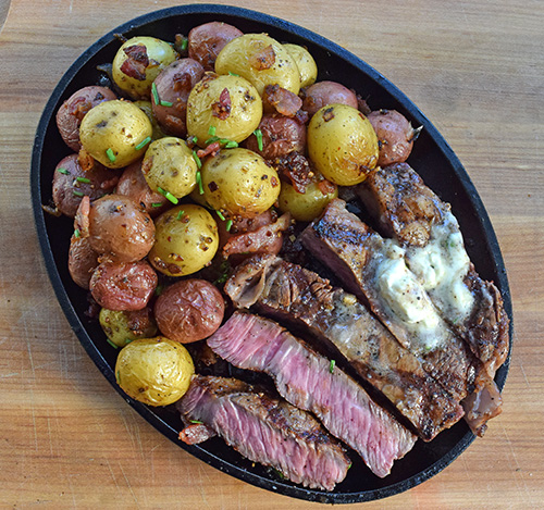 Prime Ribeye Steak with Roasted Garlic Chive Butter and Skillet Potatoes
