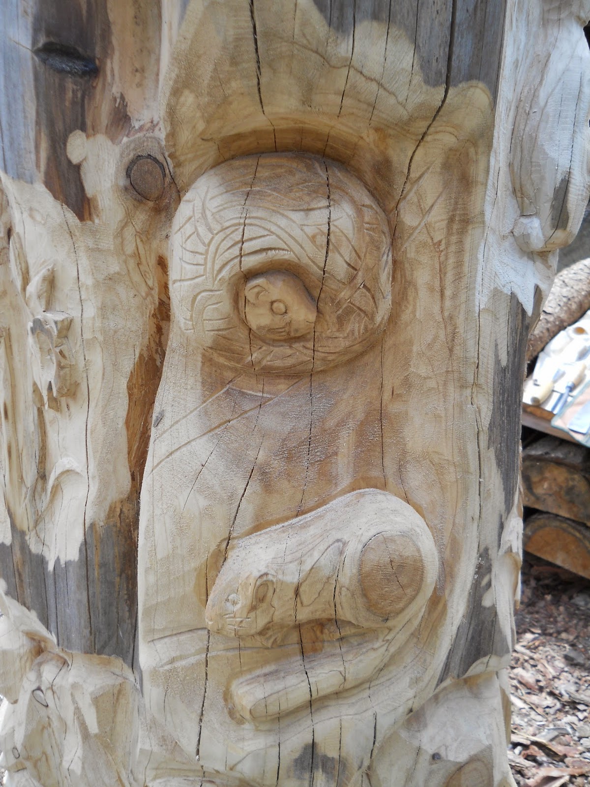 A carved cedar log as a sign for Rock Meadow, a new housing development ...