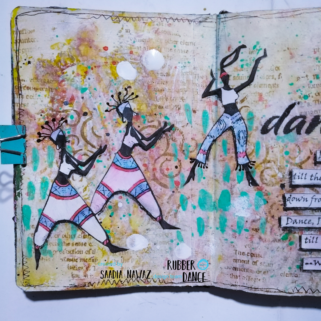 An art journal spread with the Happy Dancing stamp by Saadia