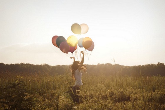 Alone happy girl with balloon sunset jump | nineimages