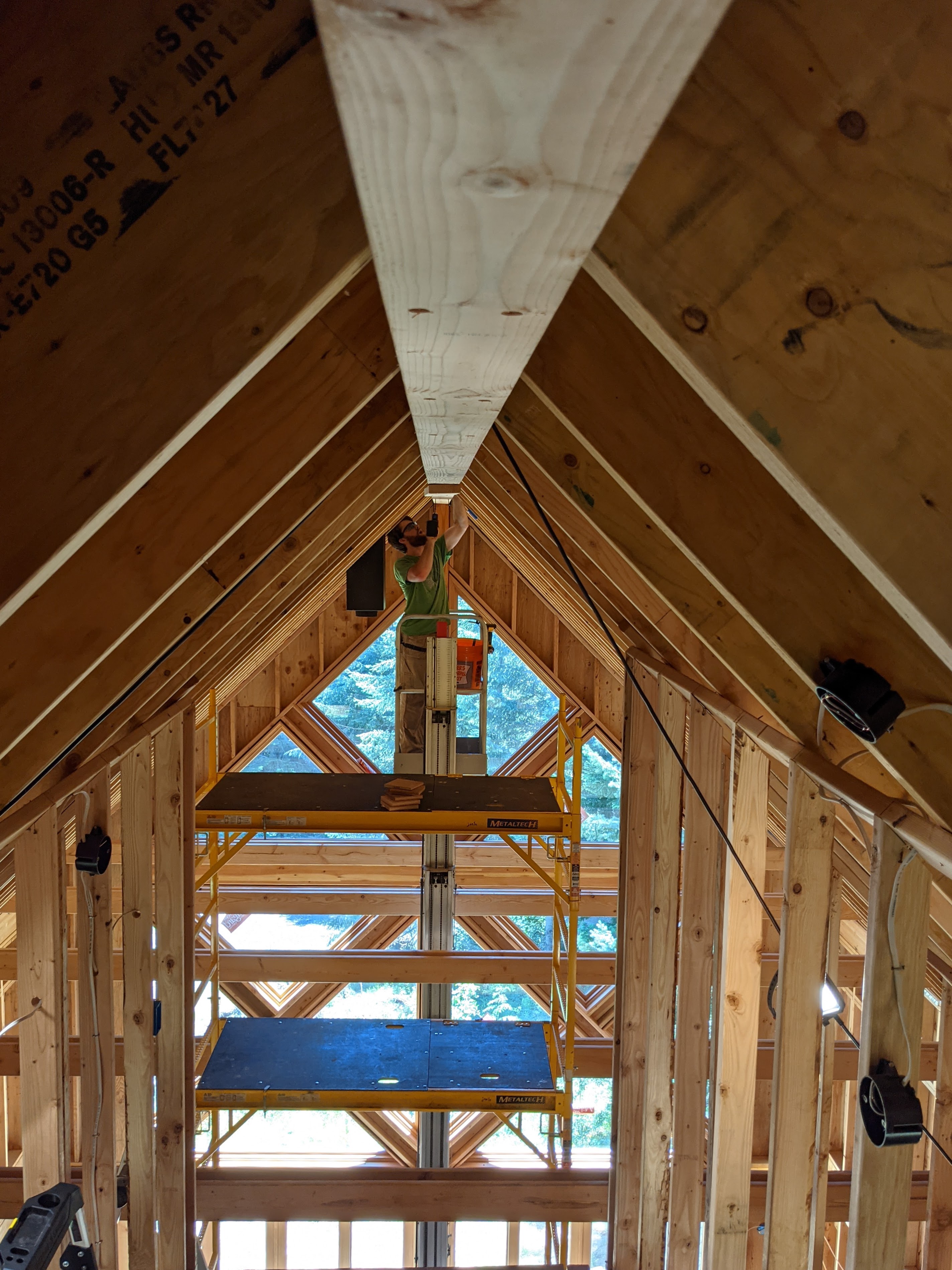 Front door, faux ridge beam, and finishing the siding