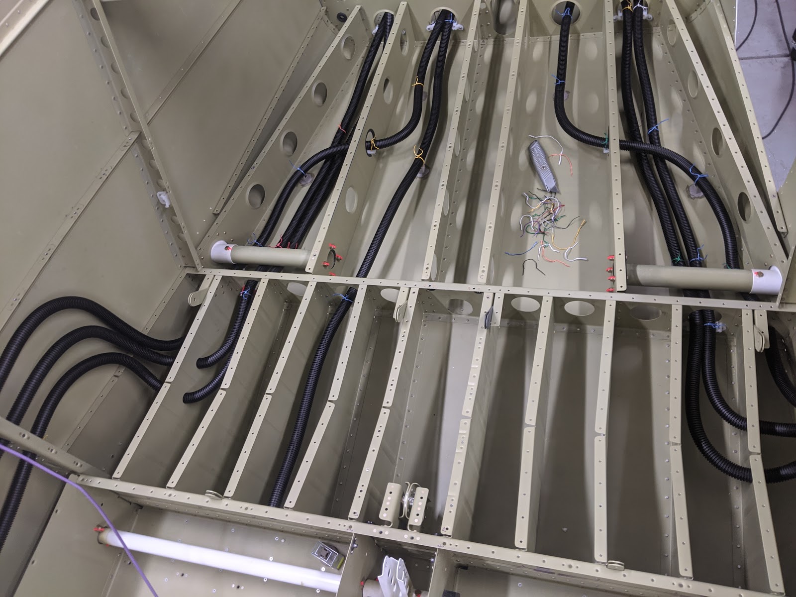 Damazio family's RV-10 project: Baggage area conduits and floors installed