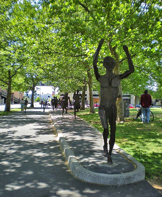 glancing back in time: the joy of running together sculptures