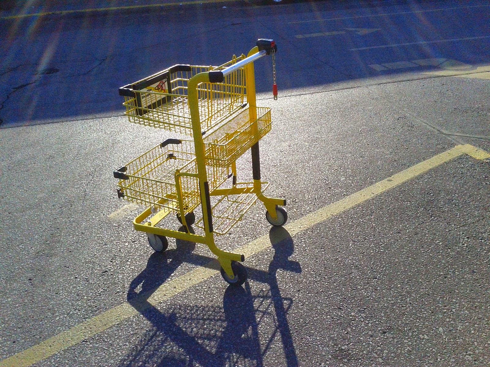 Toronto things: Stock photo: Yellow shopping cart in a parking lot