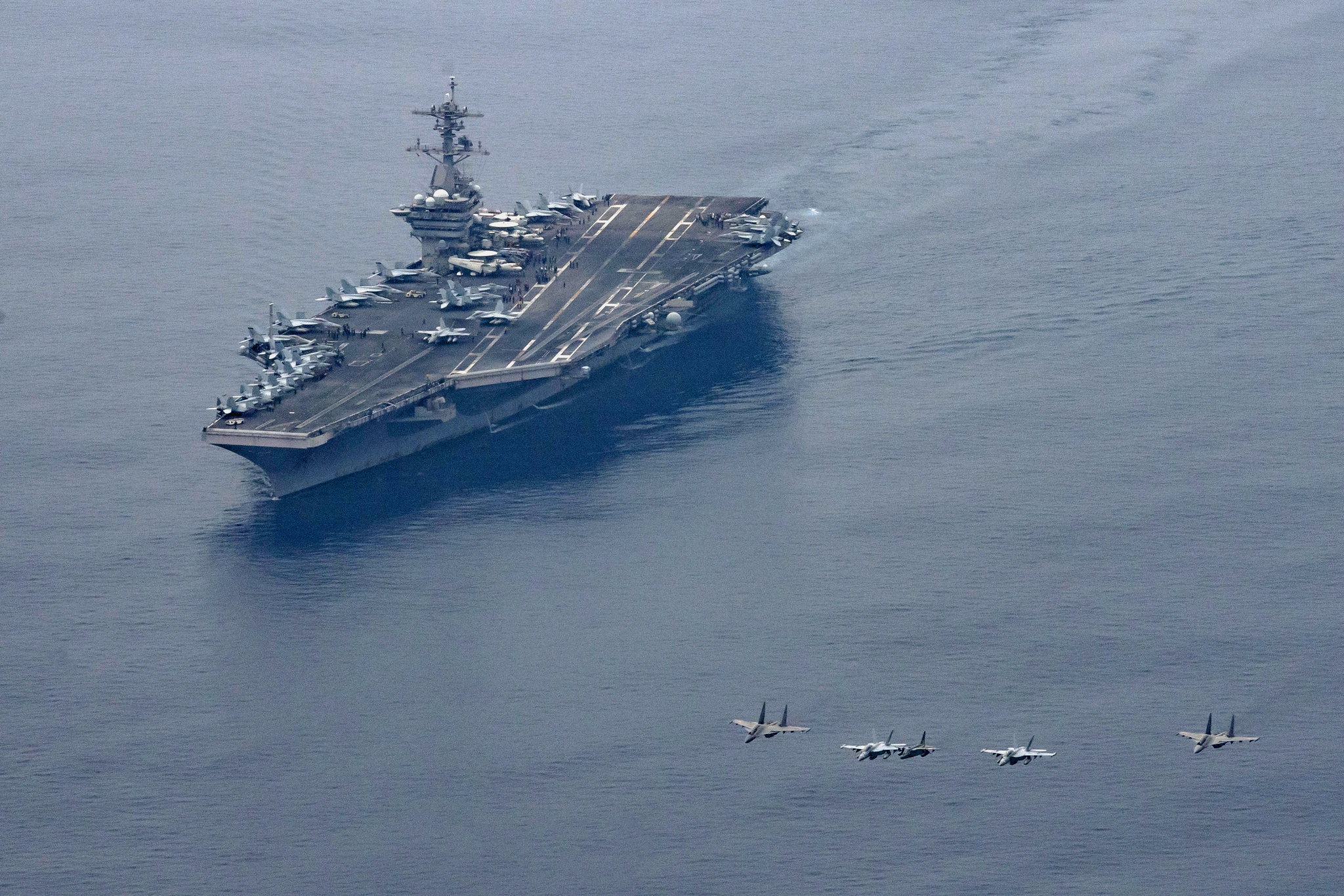 Two F/A-18 Super Hornets assigned to Carrier Air Wing 11 fly in formation with two Indian Air ...
