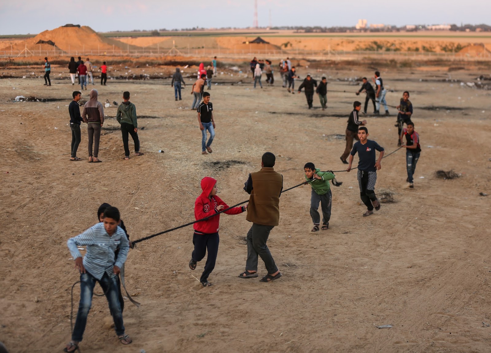 Photos: Gazans, including many children, destroy section of fence to ...