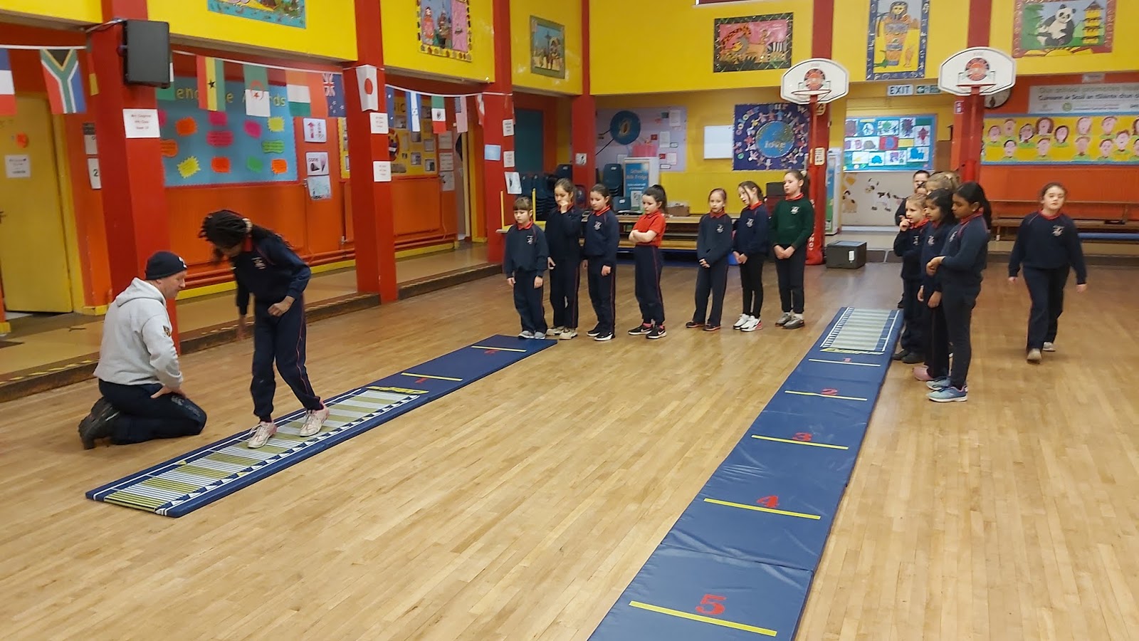 Athletics coach teaching the long jump.