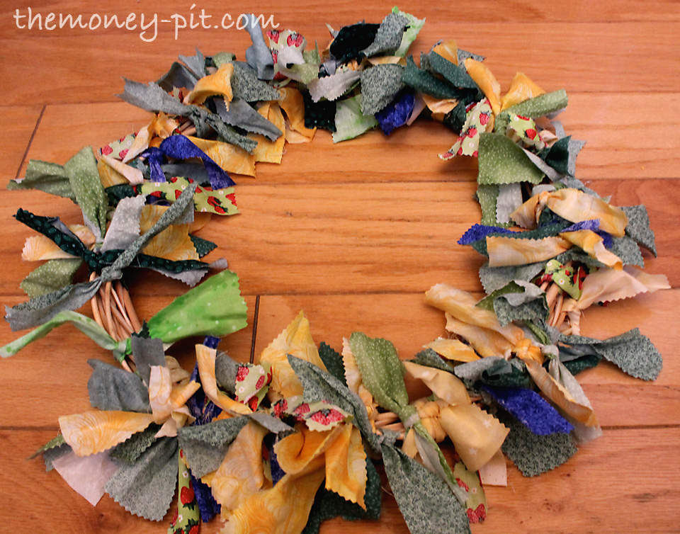 Once the wreath was pretty full, I tightly packed the knots together by ...