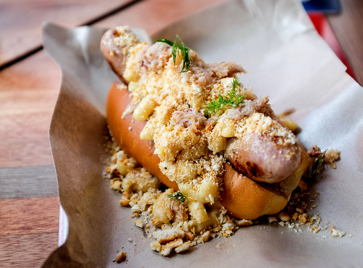 meat sausages blanketed in richly flavourful interesting toppings ...