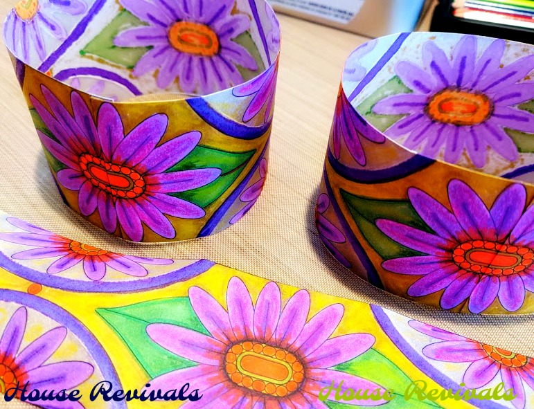 Next, form loops from two of the strips, gluing at the glue tabs, to ...